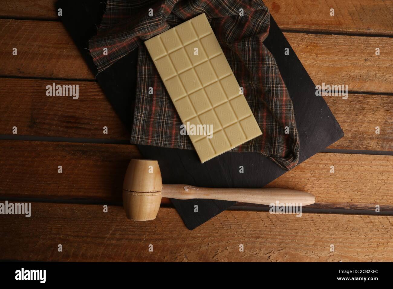 Top view of a white chocolate bar next to a small wooden mallet Stock ...