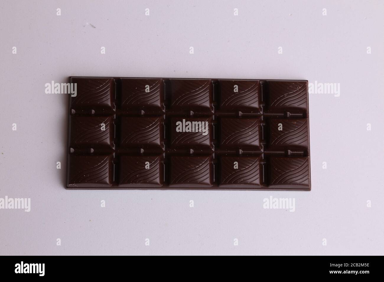 Milk chocolate tablet in color background Stock Photo - Alamy