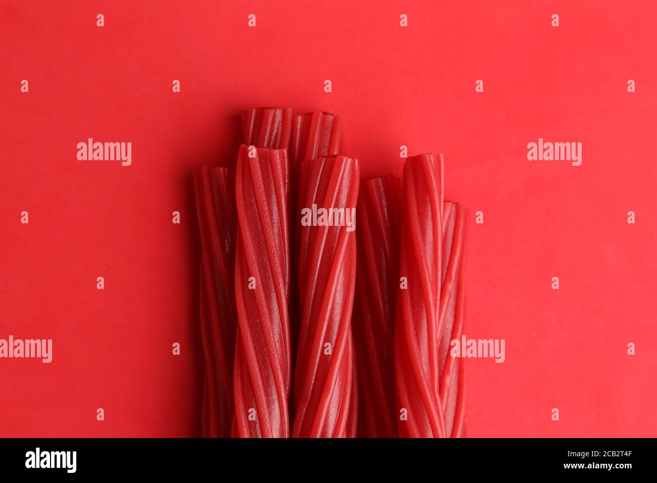 Sweet red candies on the red surface Stock Photo - Alamy