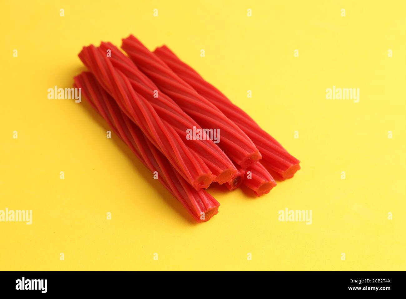 Sweet and delicious red candies on the yellow surface Stock Photo - Alamy