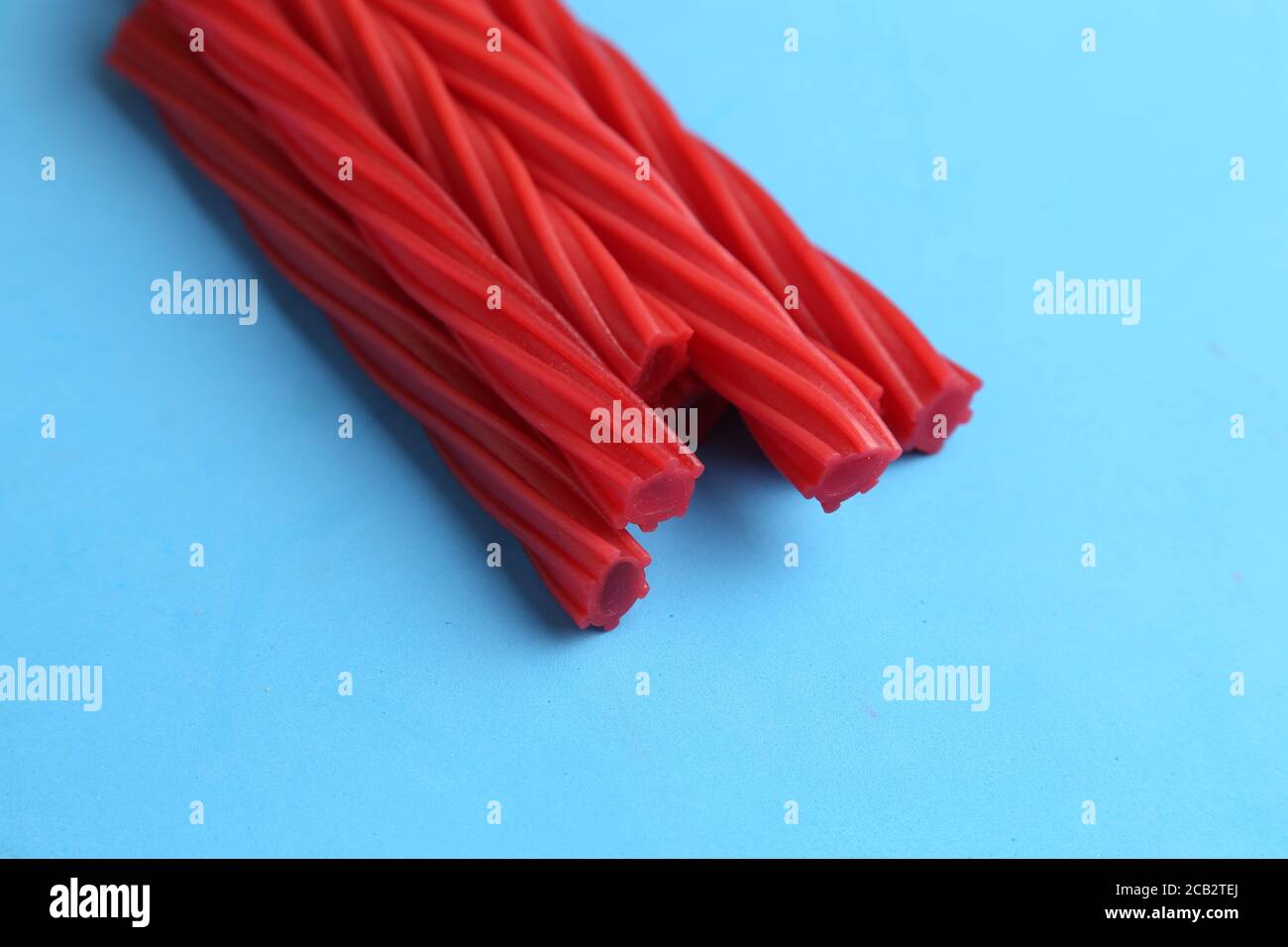 Closeup shot of a sweet red gummy licorice in color background Stock ...