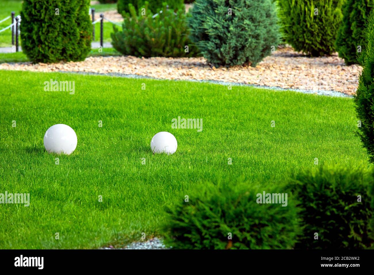 backyard with 2 electric ground lanterns with sphere diffuser lamps in ...