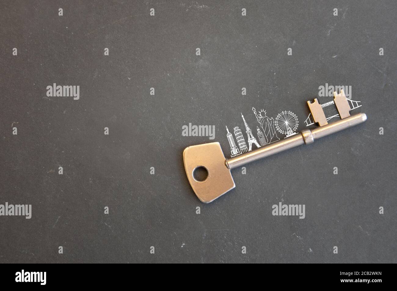 Gold key with skyline sketch of global landmarks Stock Photo - Alamy