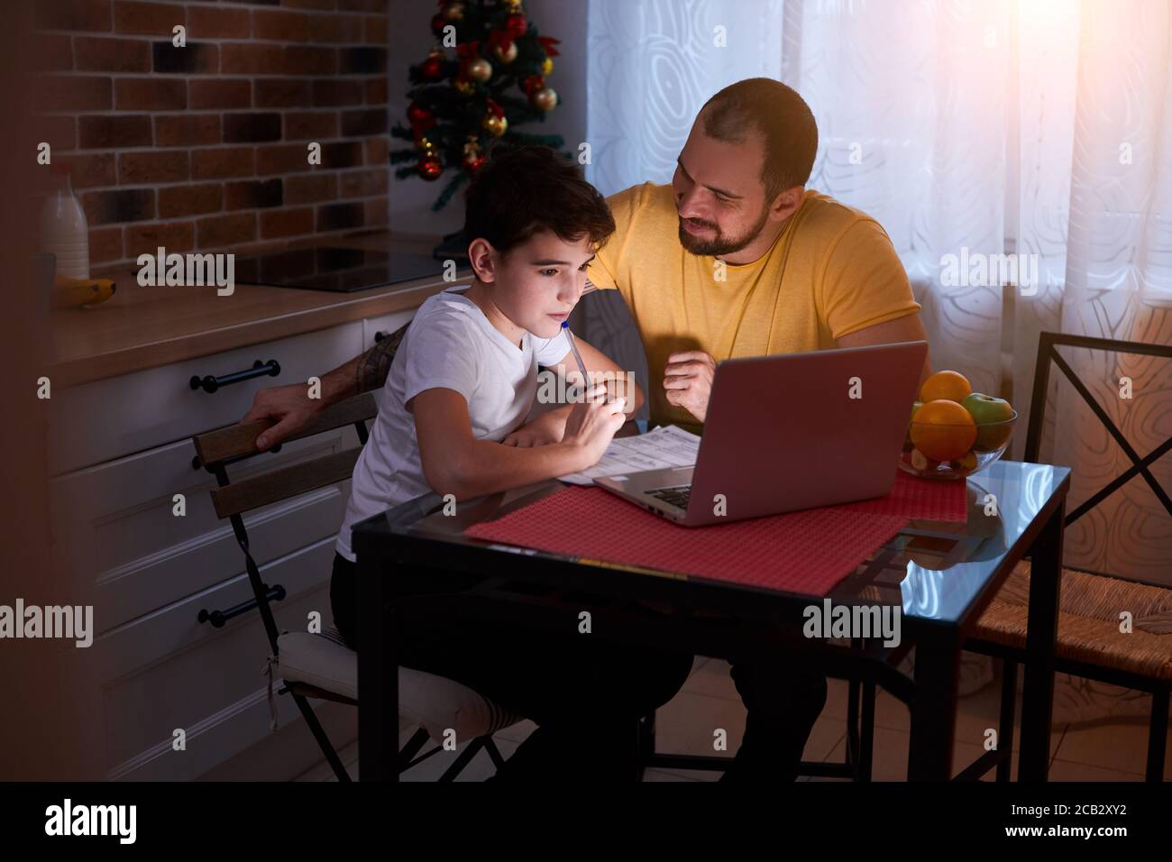 careful young father help his son to do homework at home, little kid ...