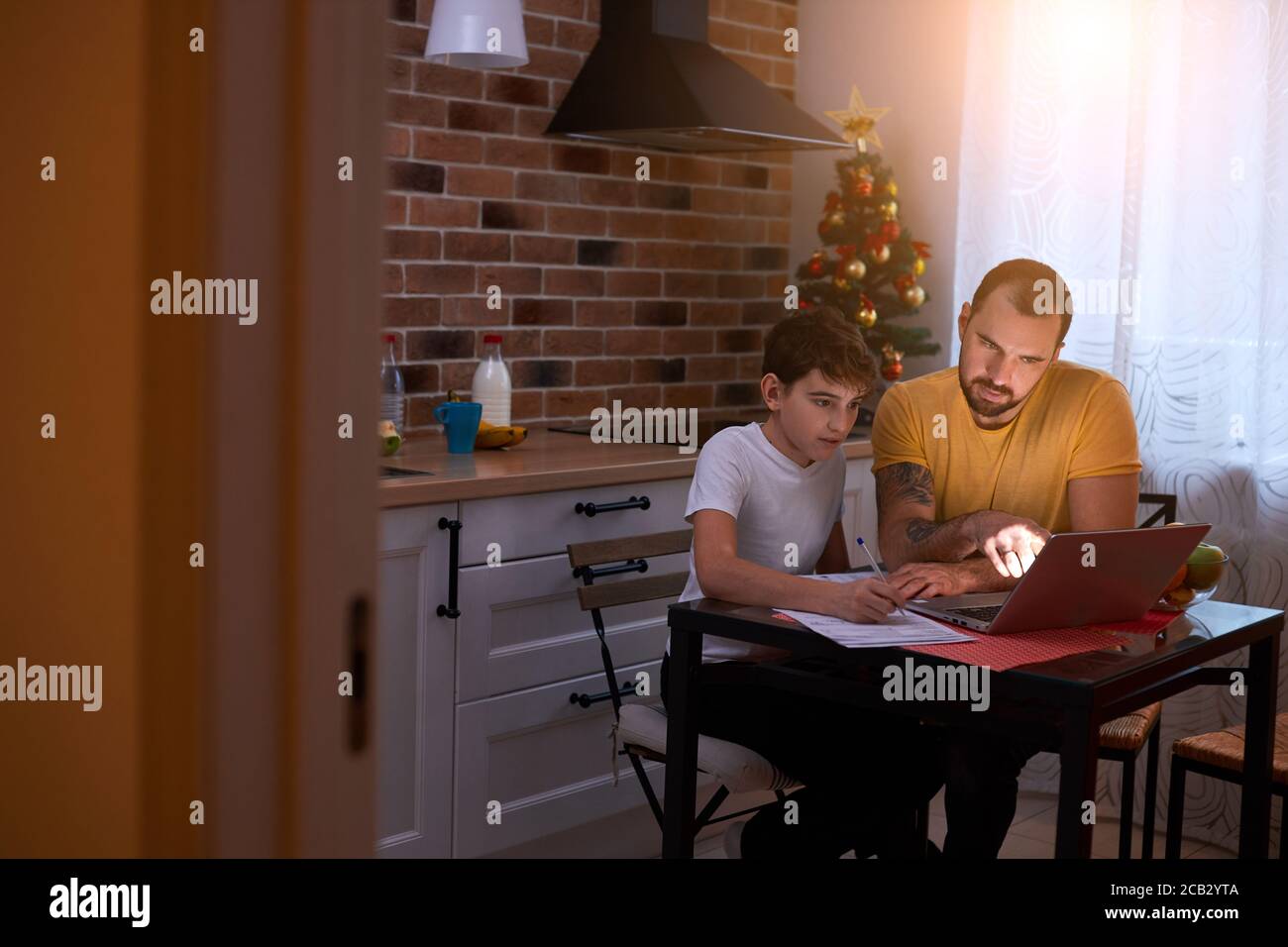 attentive and careful father help kid boy, son to study, to do ...