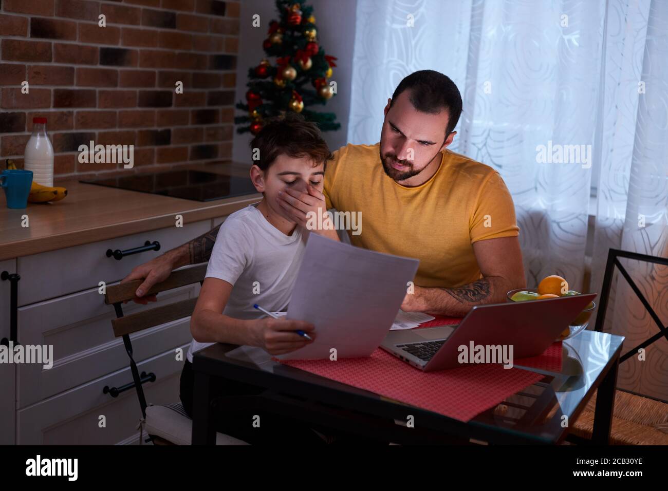 careful young father help his son to do homework at home, little kid ...
