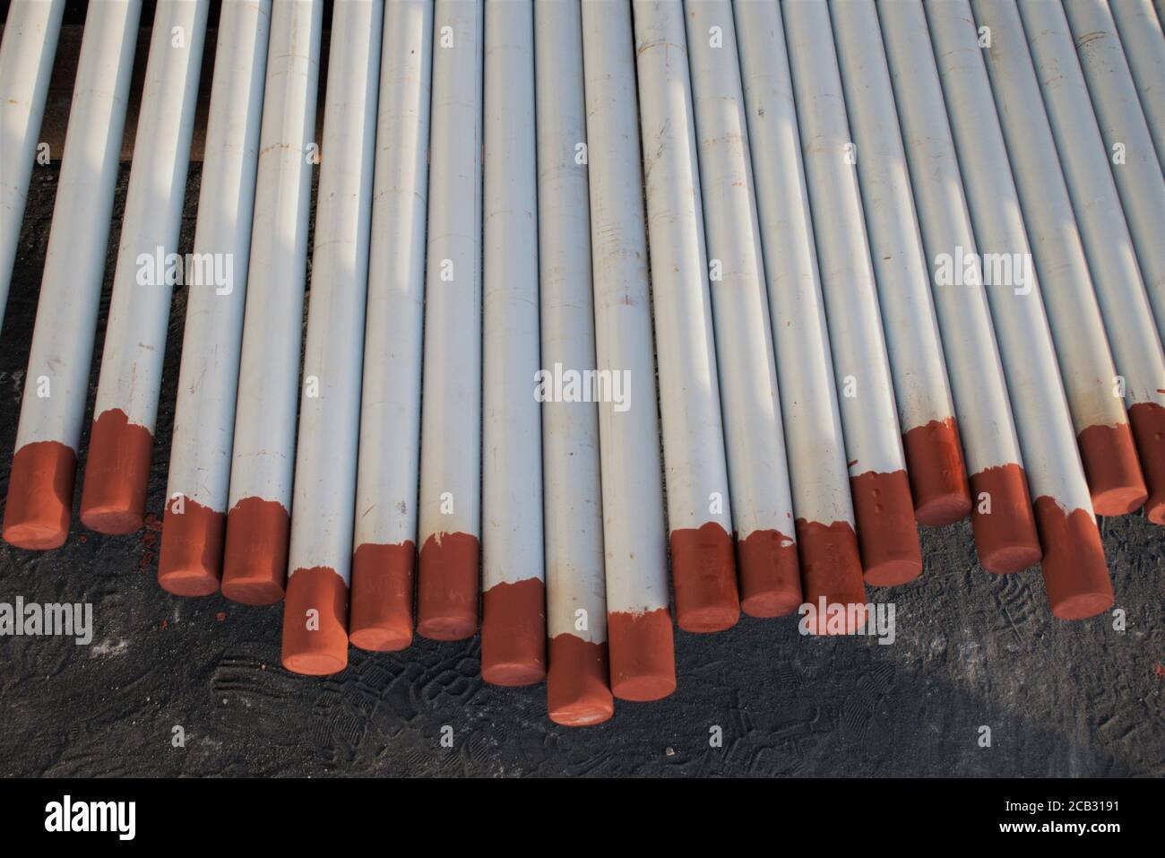 white pipes with red end Stock Photo - Alamy