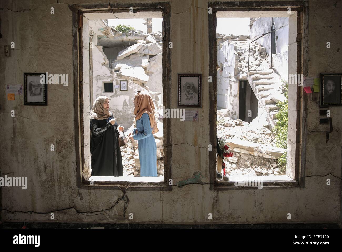 Idlib City, Syria. 10th Aug, 2020. Visitors tour an exhibition set up ...