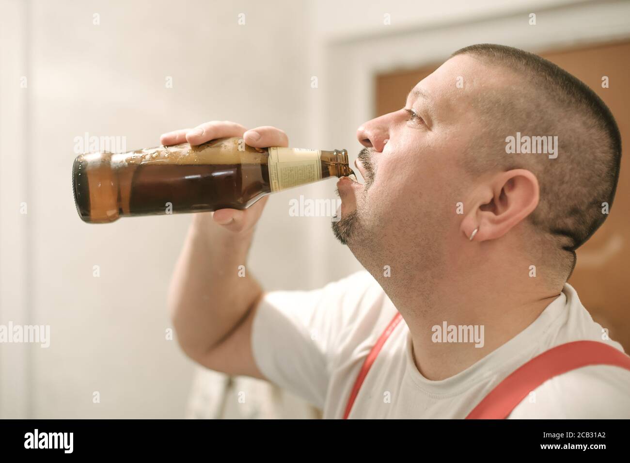 Portrait of construction mason worker drinking beer during working ...