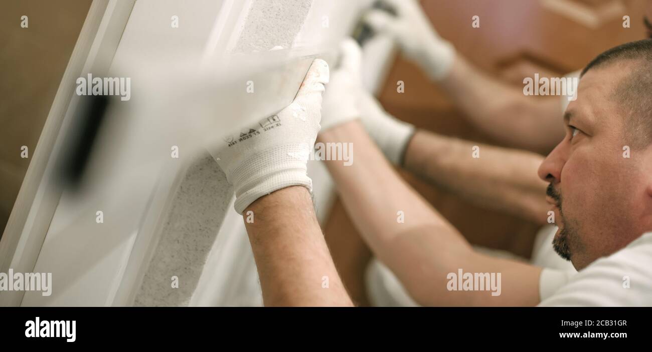 Construction worker with spirit level working on home renovations Stock ...
