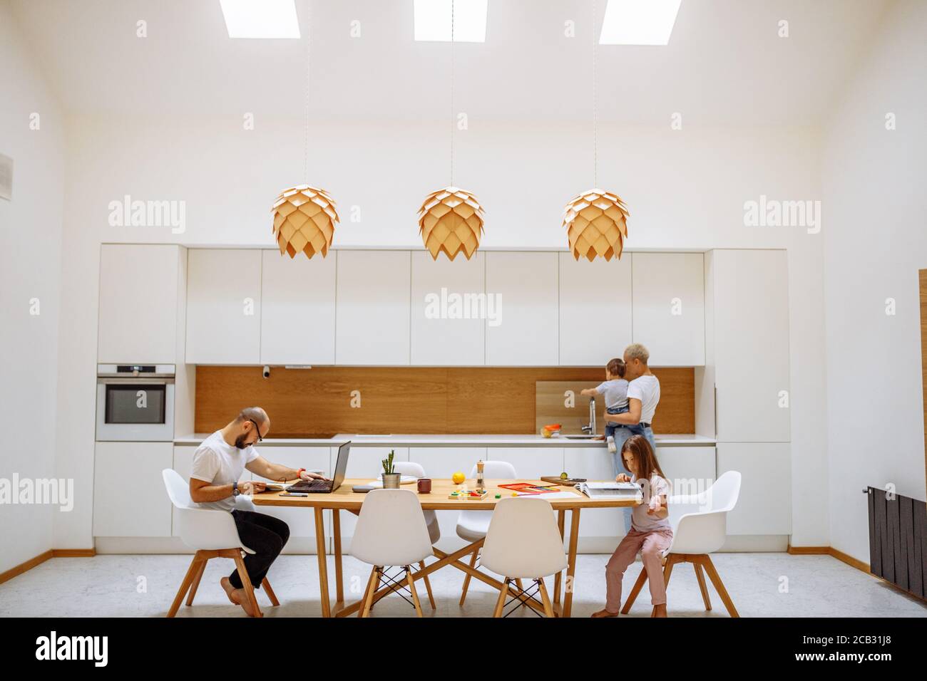 Daytime with family at home. Father busy working from home, using ...