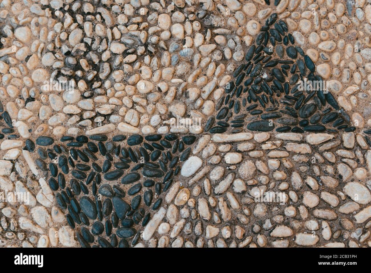 Closeup shot of pebble mosaic sidewalk Stock Photo - Alamy