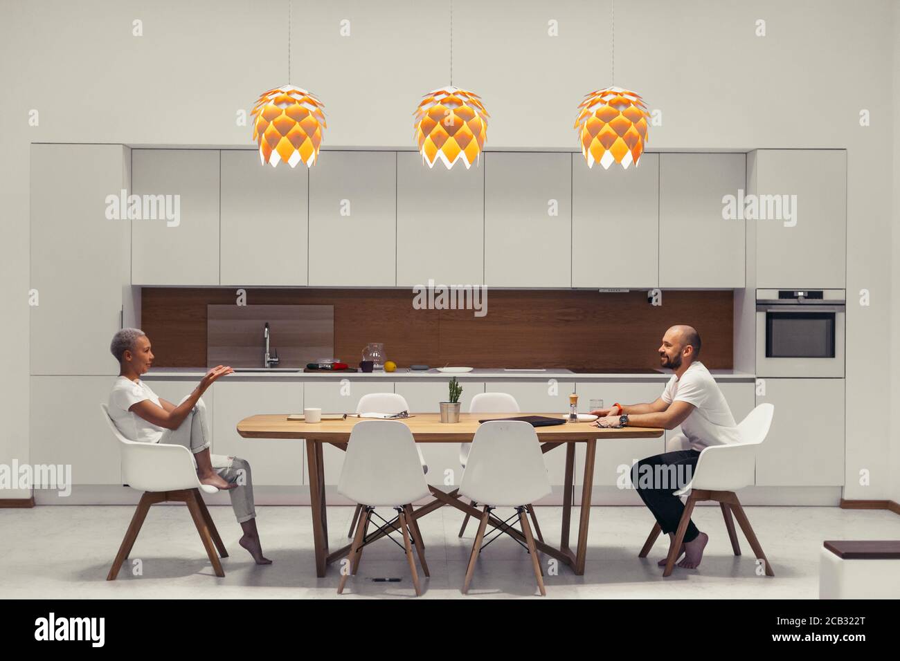 Happy family couple, wife and husband sit opposite on another look ...