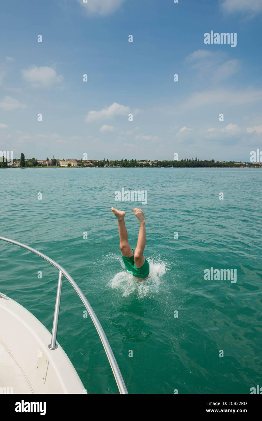 Boy jumping boat hi-res stock photography and images - Alamy