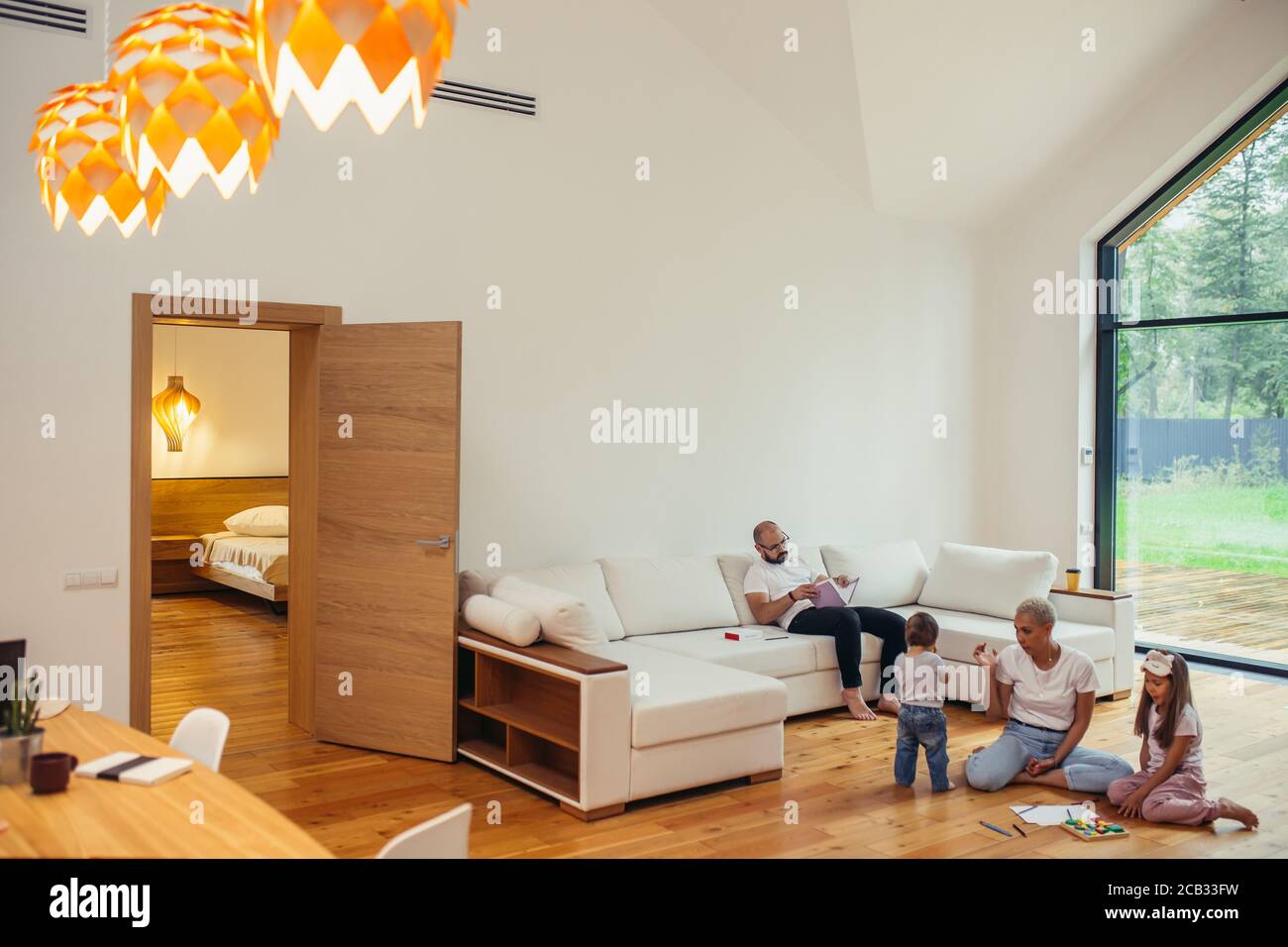 Family have rest at home with white interior. Best place to relax ...