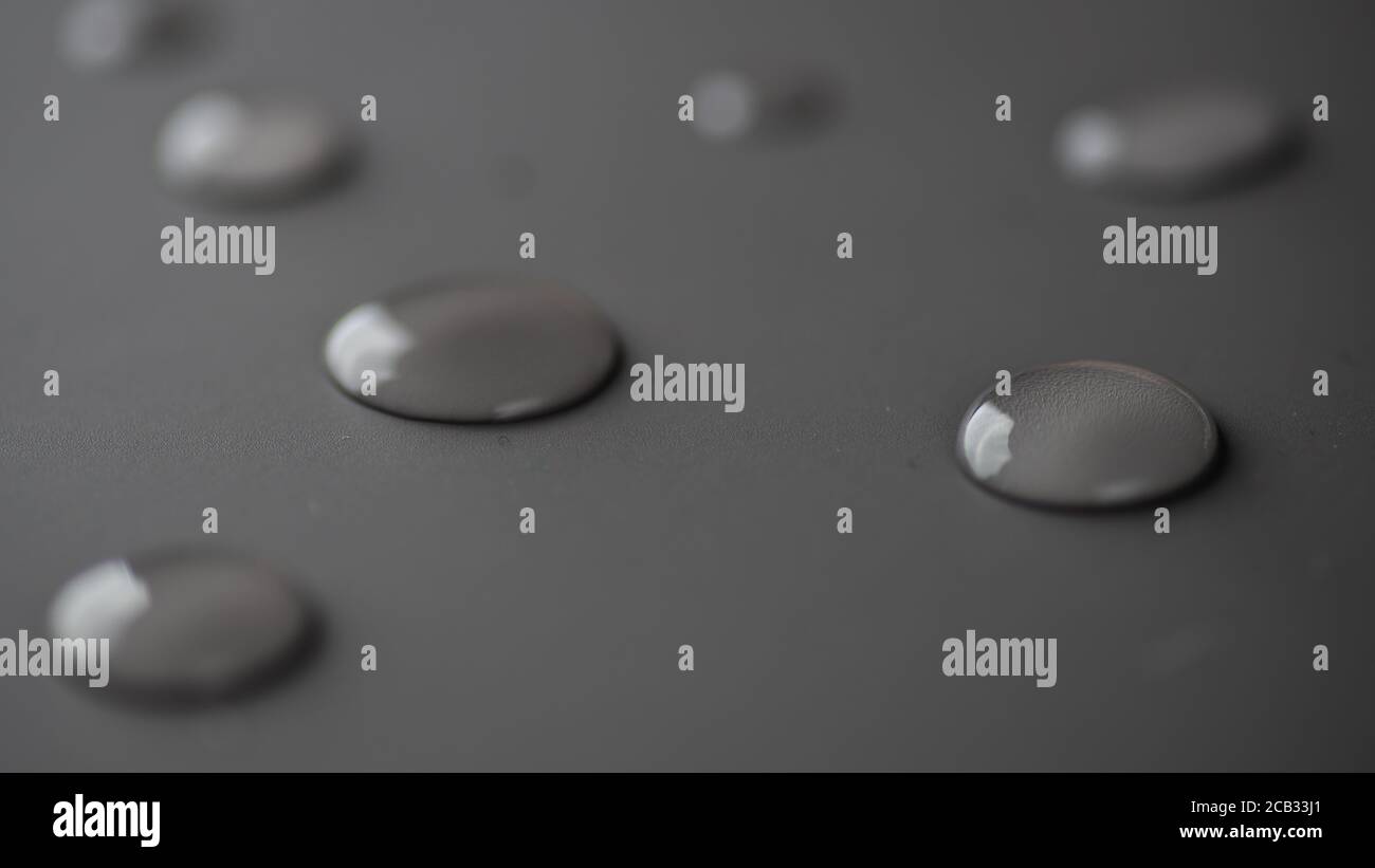 Water droplets on flat grey surface Stock Photo - Alamy
