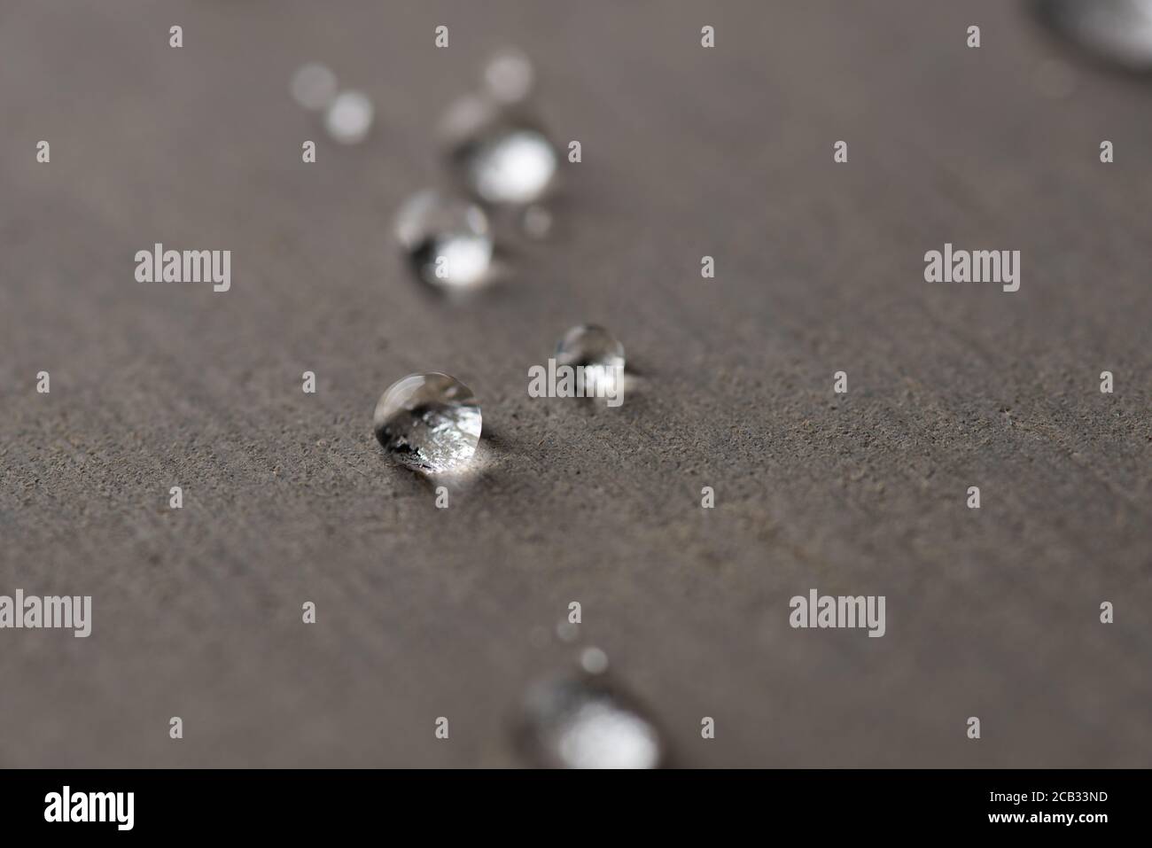 Water droplets on flat grey surface Stock Photo - Alamy