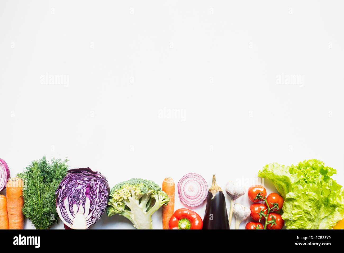 border of colorful assorted fresh vegetables on white background with ...