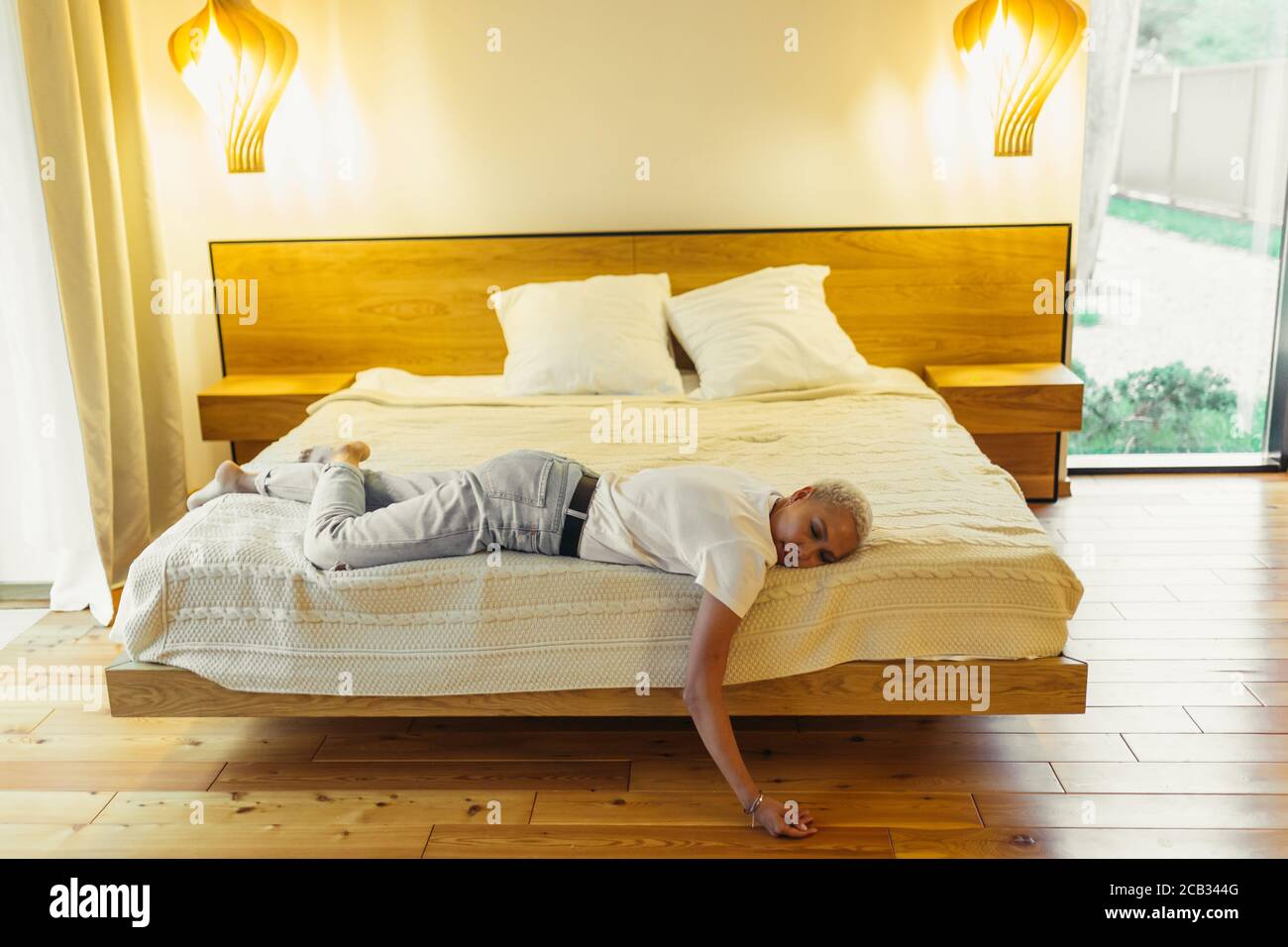 Young woman lying on edge hi-res stock photography and images - Alamy