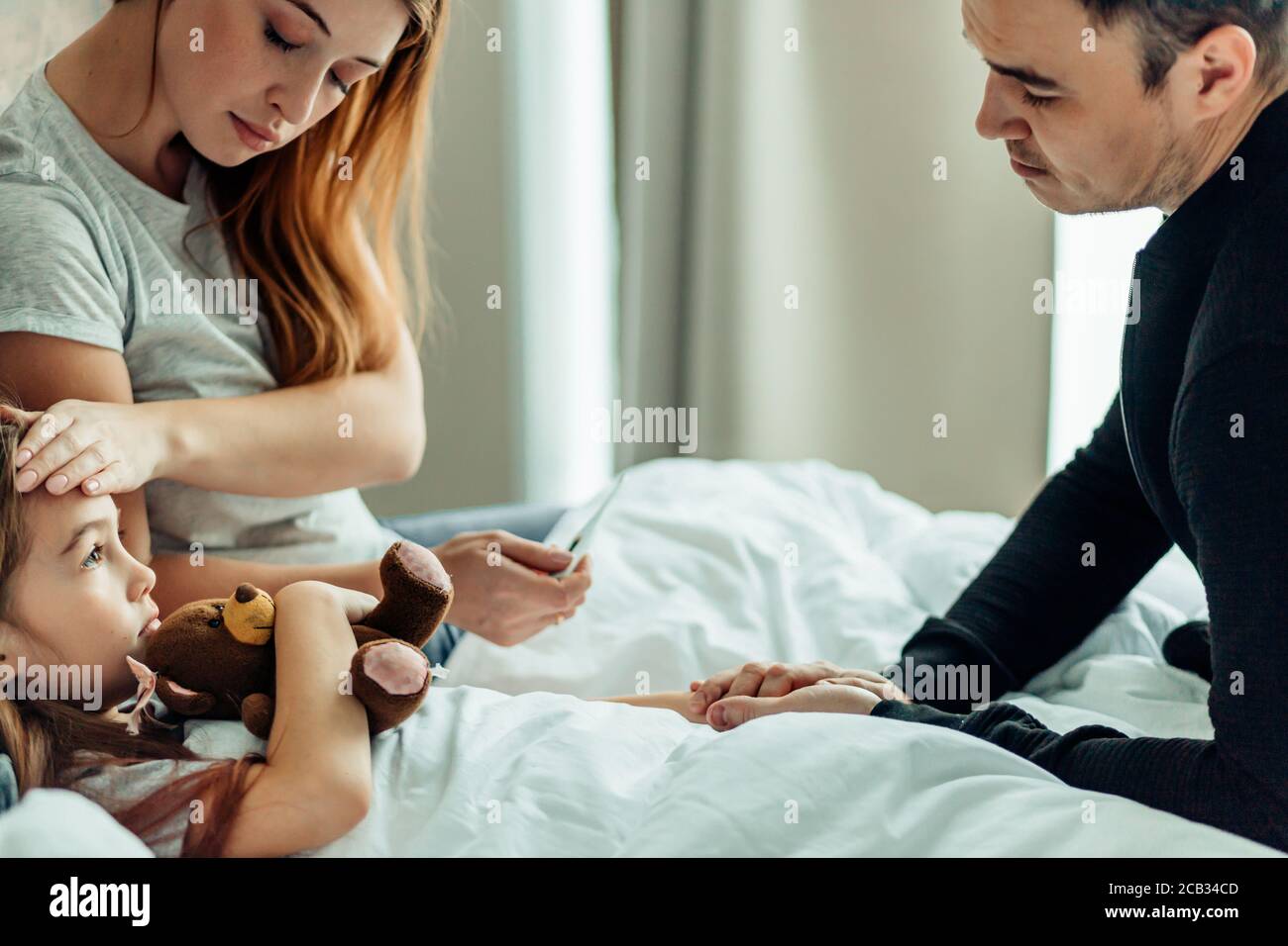 family concept. caucasian woman check temperature of sweet daughter ...