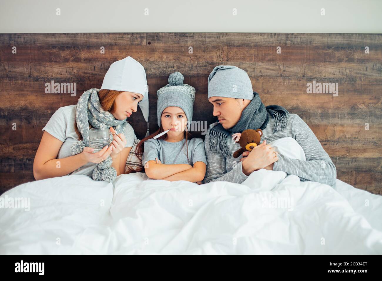 portrait of sick kid girl having fever, suffering from snuffle, parents ...