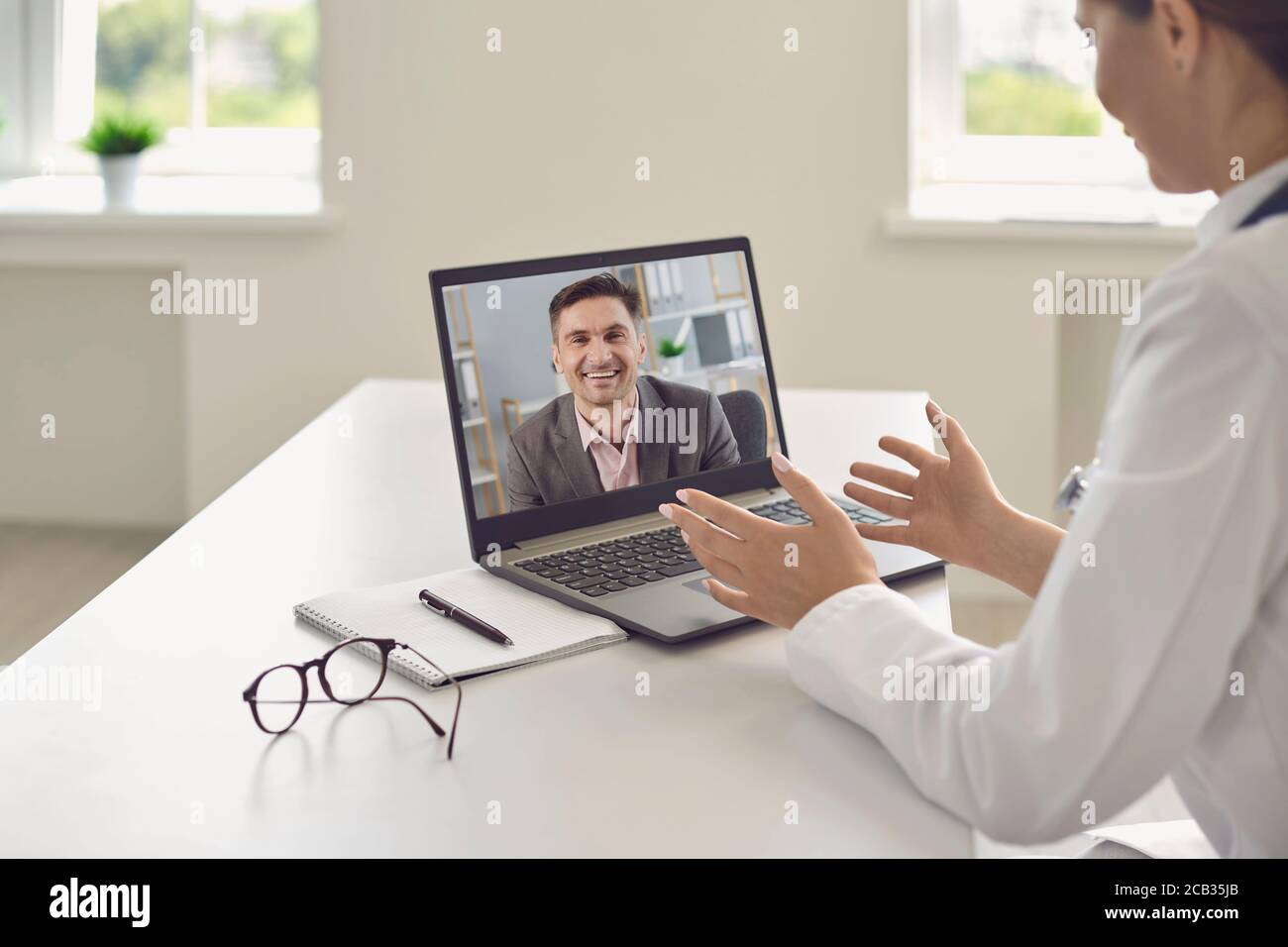 Online medical service. Female doctor giving virtual consultation to ...