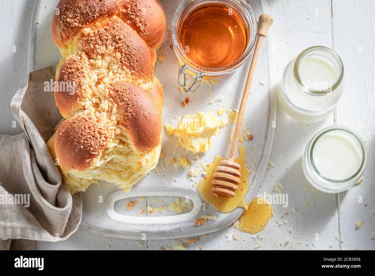 Fresh challah with honey and milk in the morning Stock Photo - Alamy