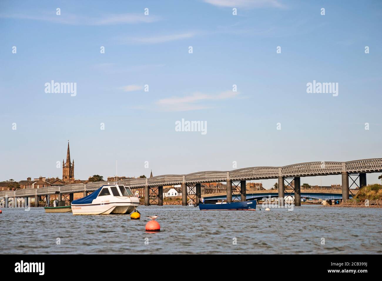Landscape image from Montrose basin of boats and railway bridge with ...