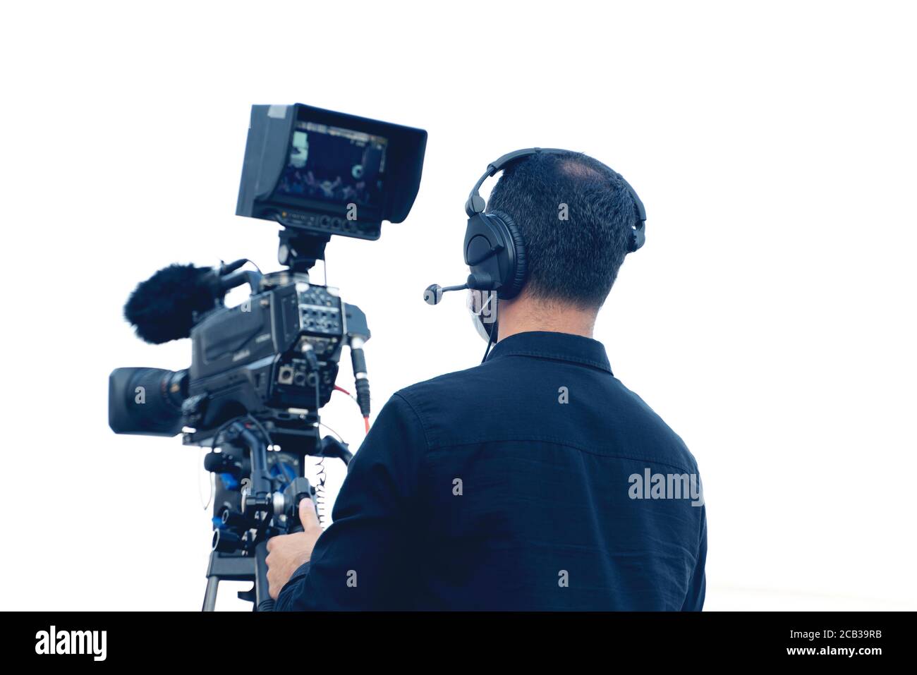 Cameraman on the set of the ultimate concert show. Masked against ...