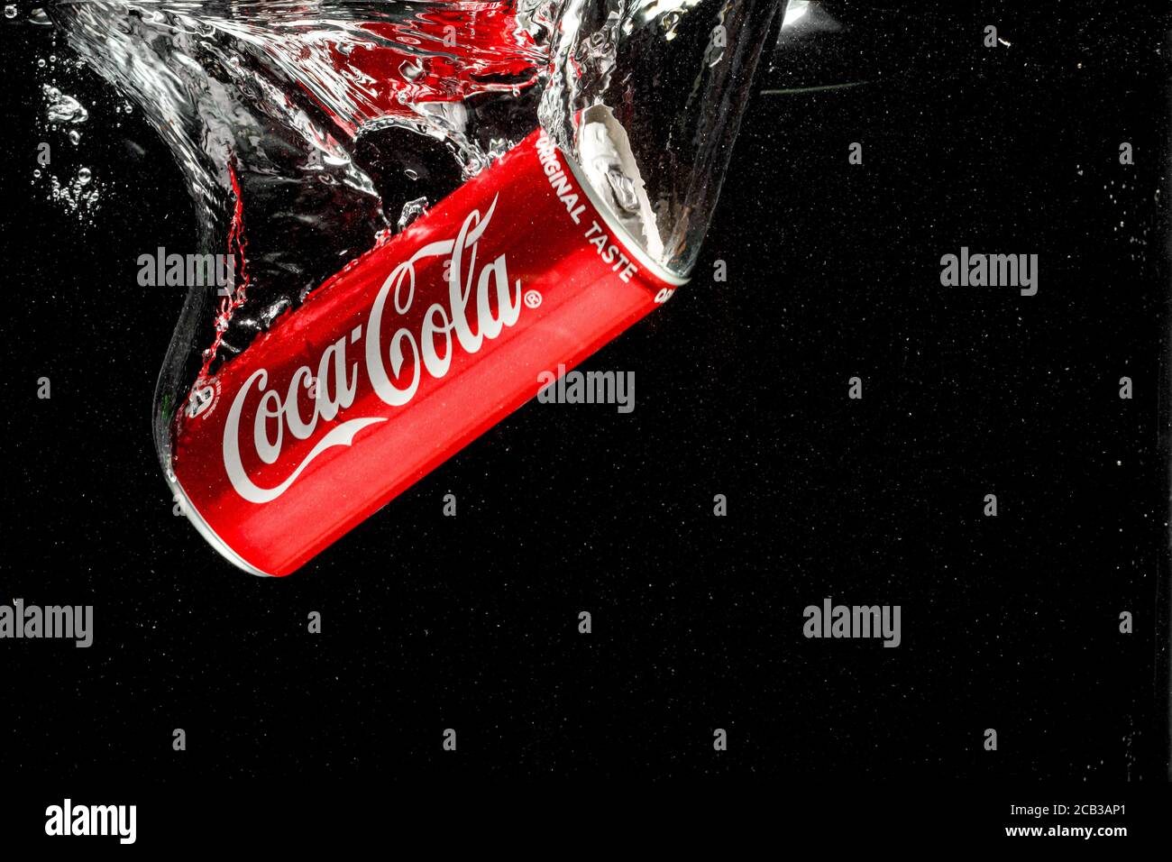 Coca cola can splashing in to water on black background Stock Photo - Alamy