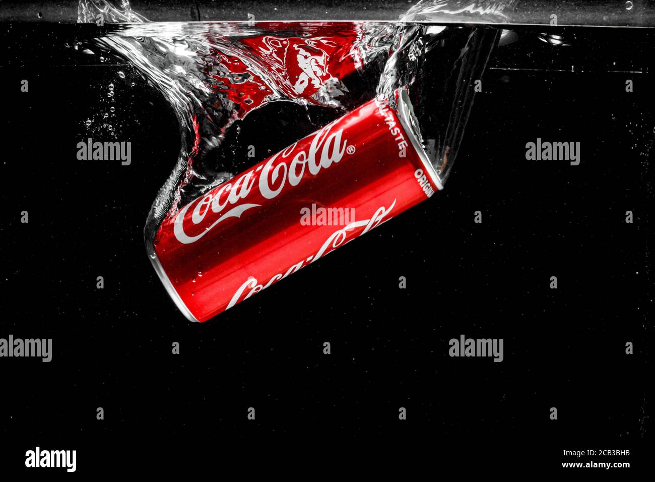 Coca cola can splashing in to water on black background Stock Photo - Alamy
