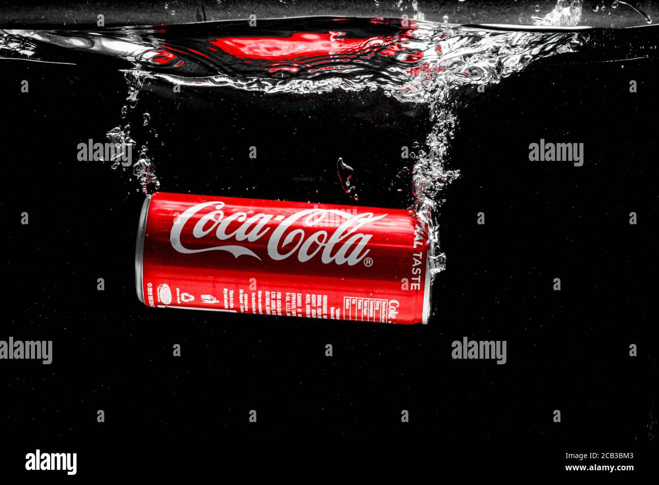 Coca cola can splashing in to water on black background Stock Photo - Alamy