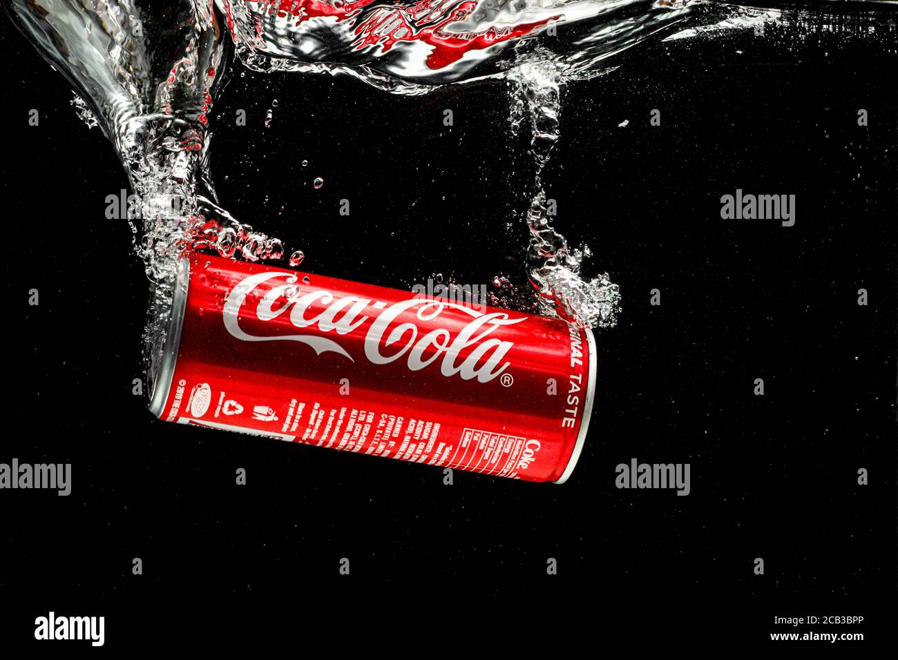 Coca cola can splashing in to water on black background Stock Photo - Alamy