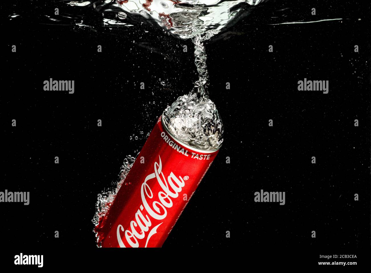 Coca cola can splashing in to water on black background Stock Photo - Alamy