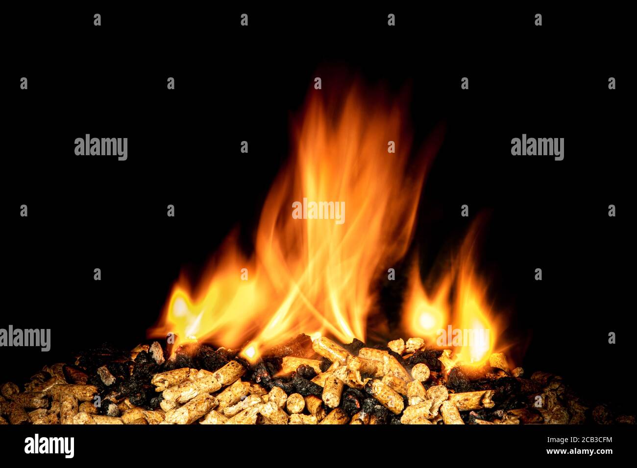 wood pellets burning with flames on black. Ecological and natural fuel ...
