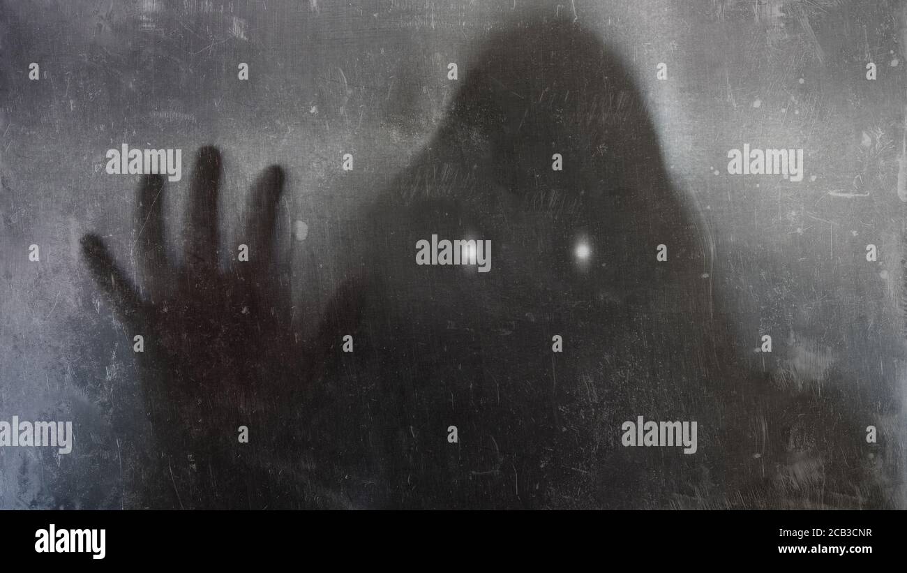 A ghostly hooded figure with glowing eyes. With a blurred, vintage ...