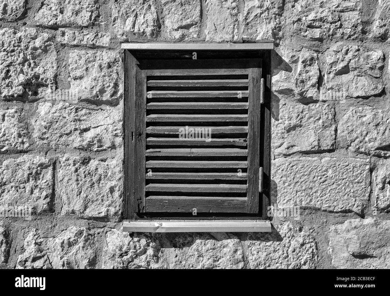 Beautiful old window frame with old wooden shutters on ancient pale ...
