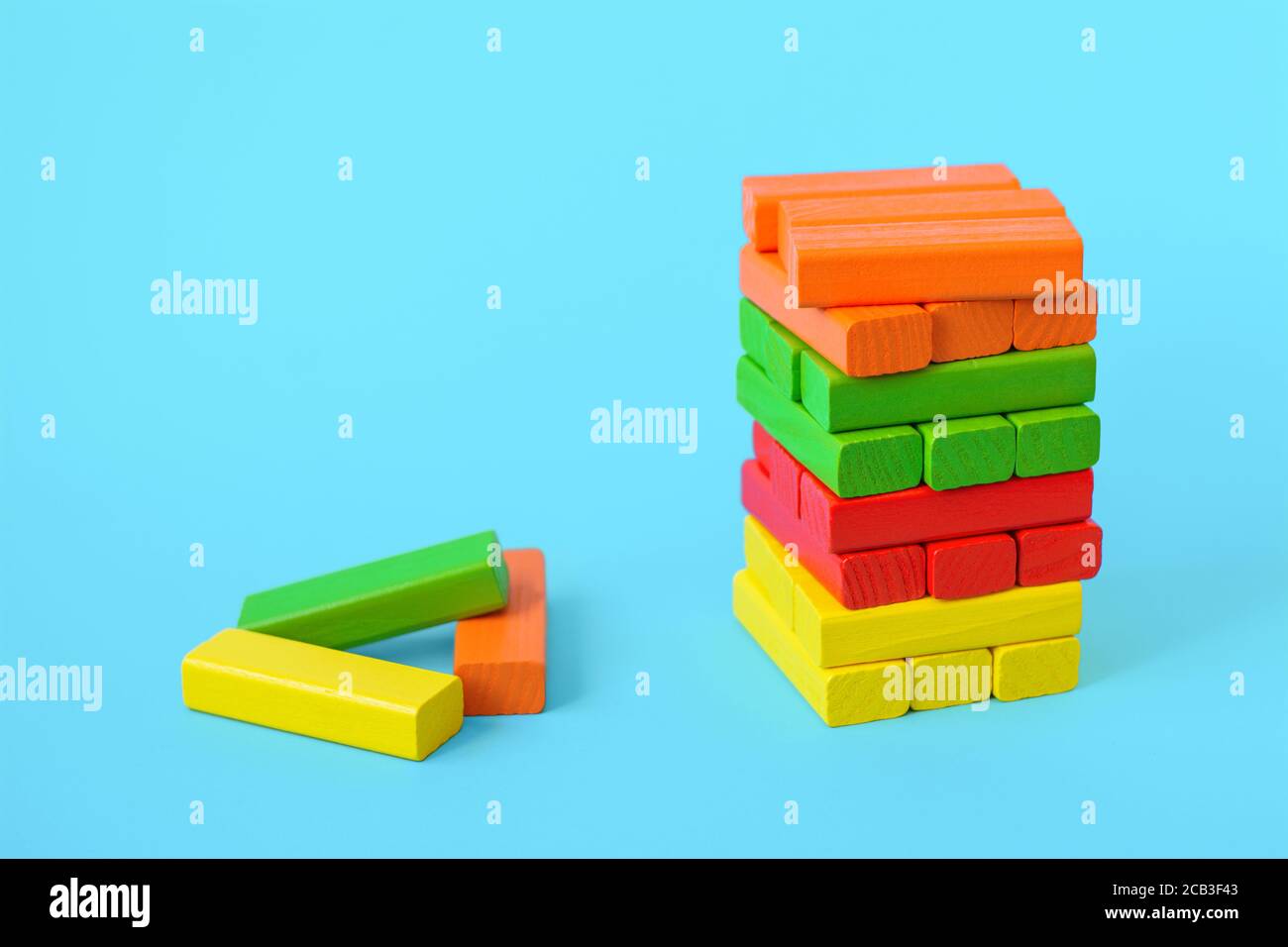 Colorful jenga blocks on a blue background, tower game Stock Photo - Alamy
