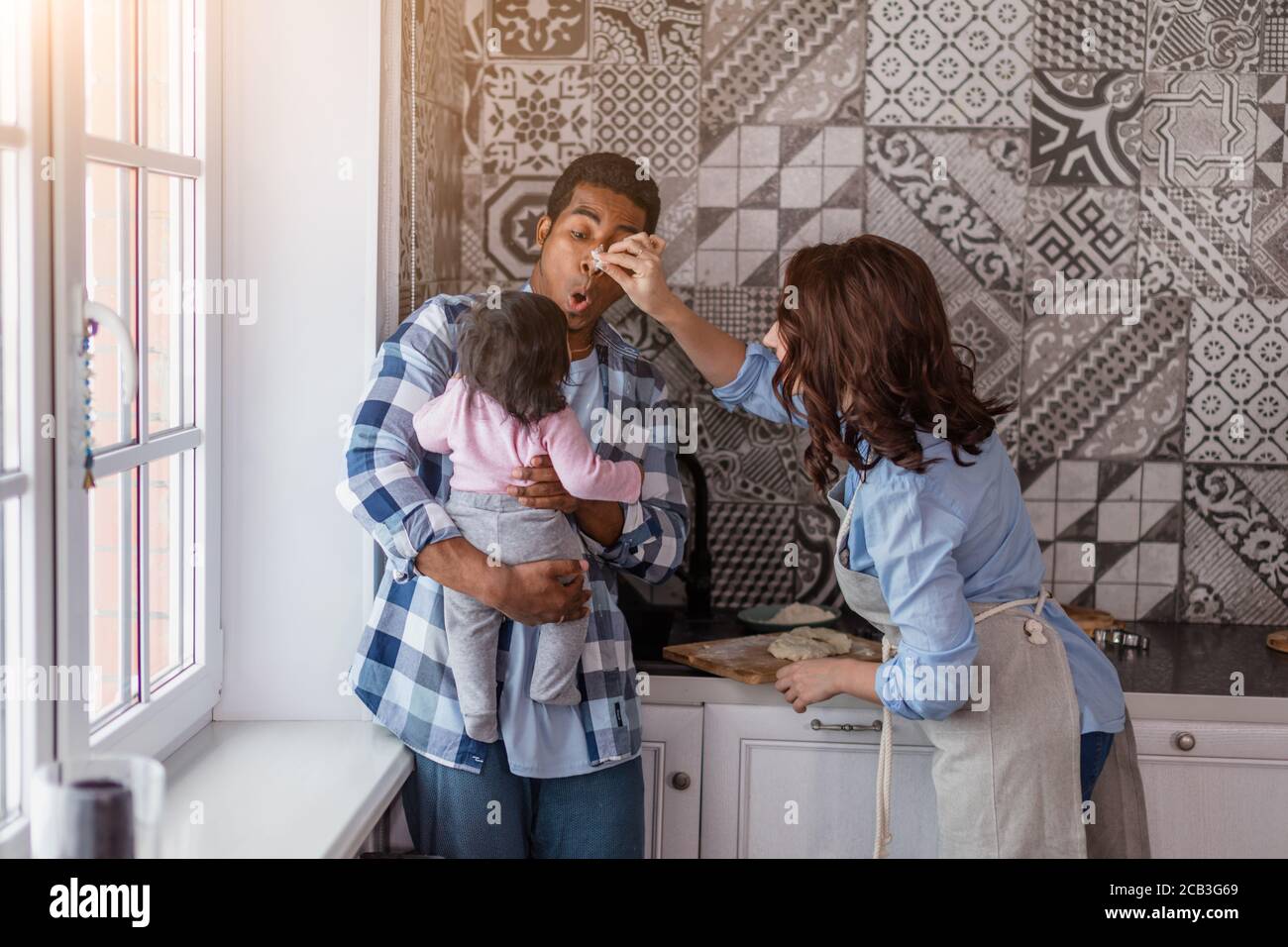 crazy parents entertaining their lovely child, close up photo ...