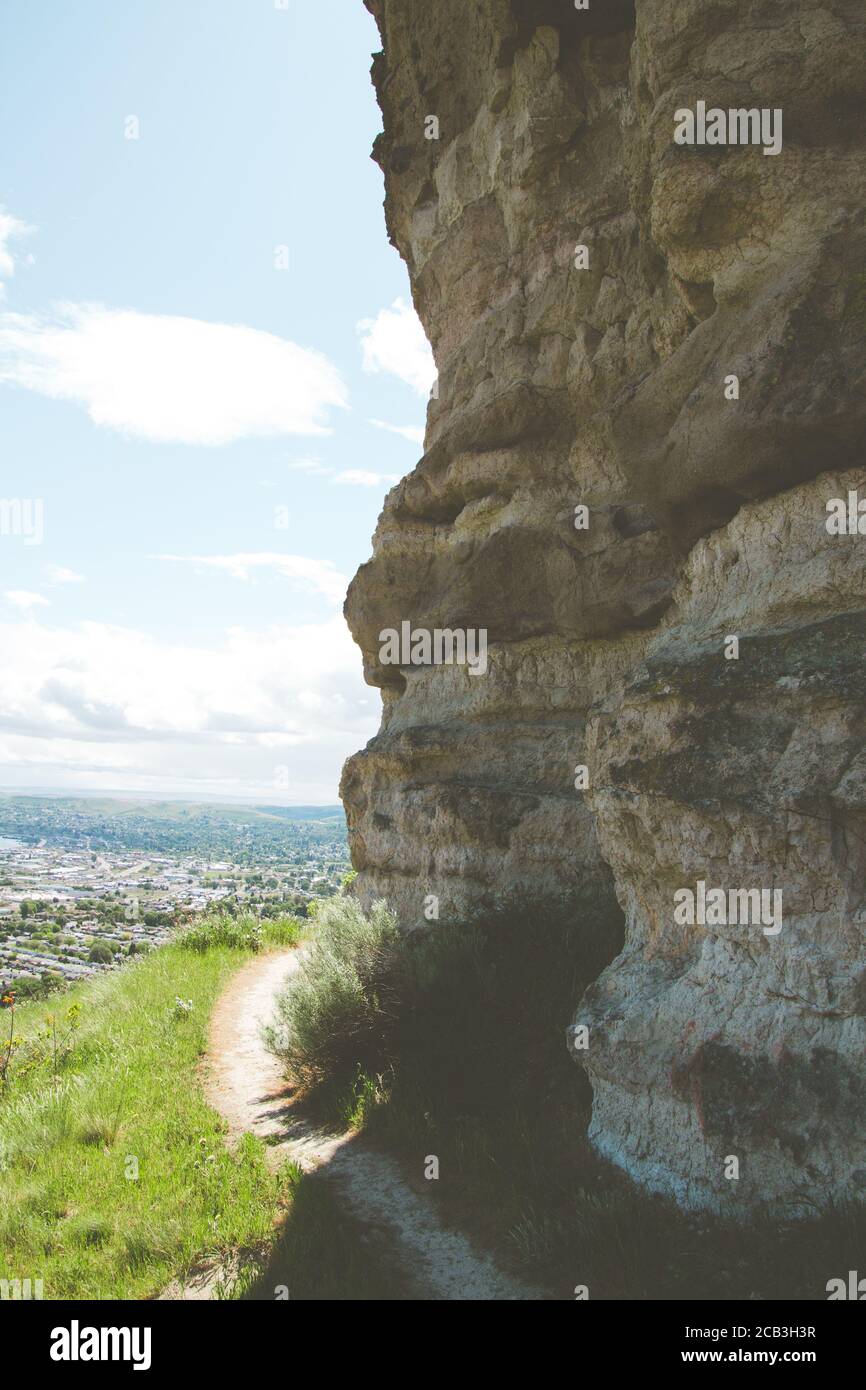 Vertical shot of the cliff with a cloudy blue sky background Stock ...
