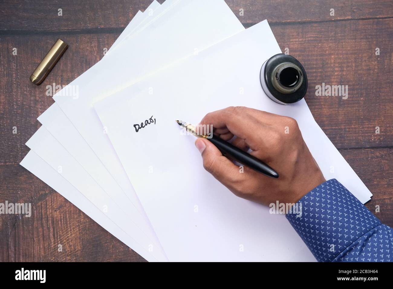 Top view of man hand writing a letter with fountain pen Stock Photo - Alamy