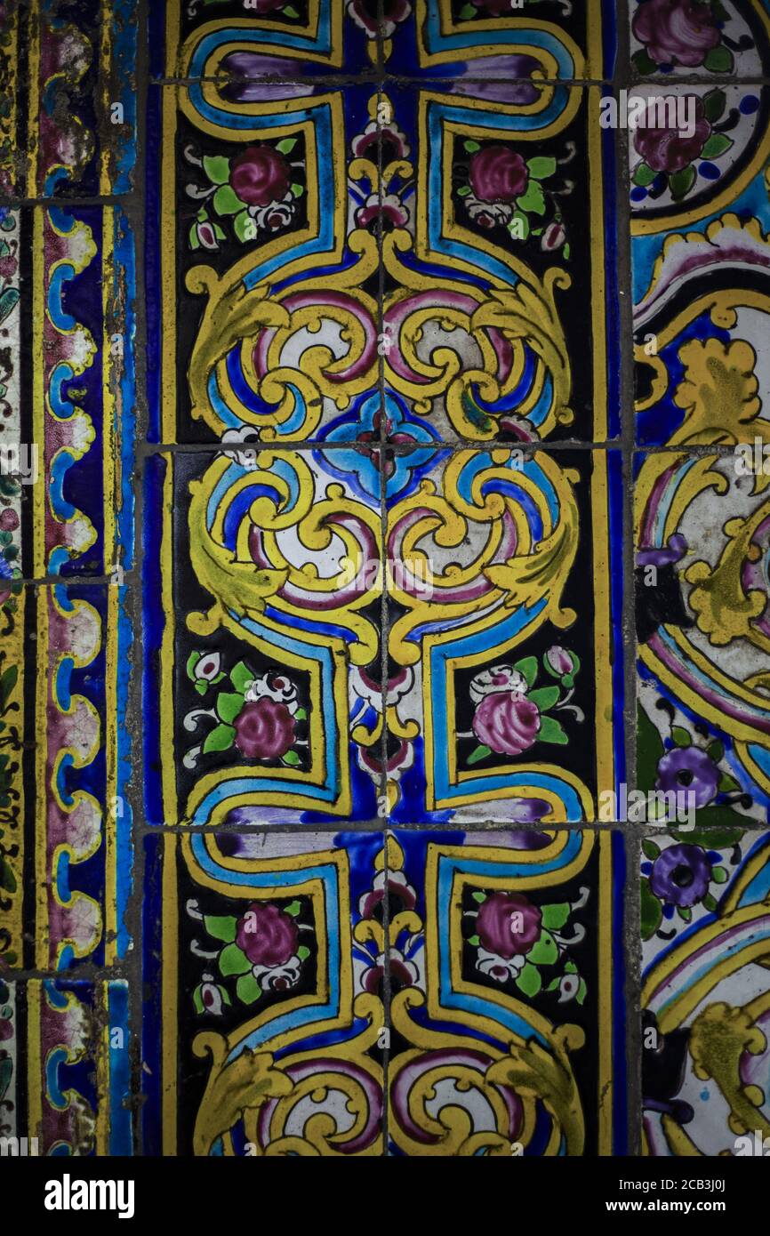 Vertical shot of a ceramic wall texture with painted colorful patterns ...