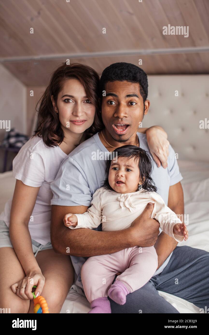 scared father and daughter looking aside while mother posing to the ...