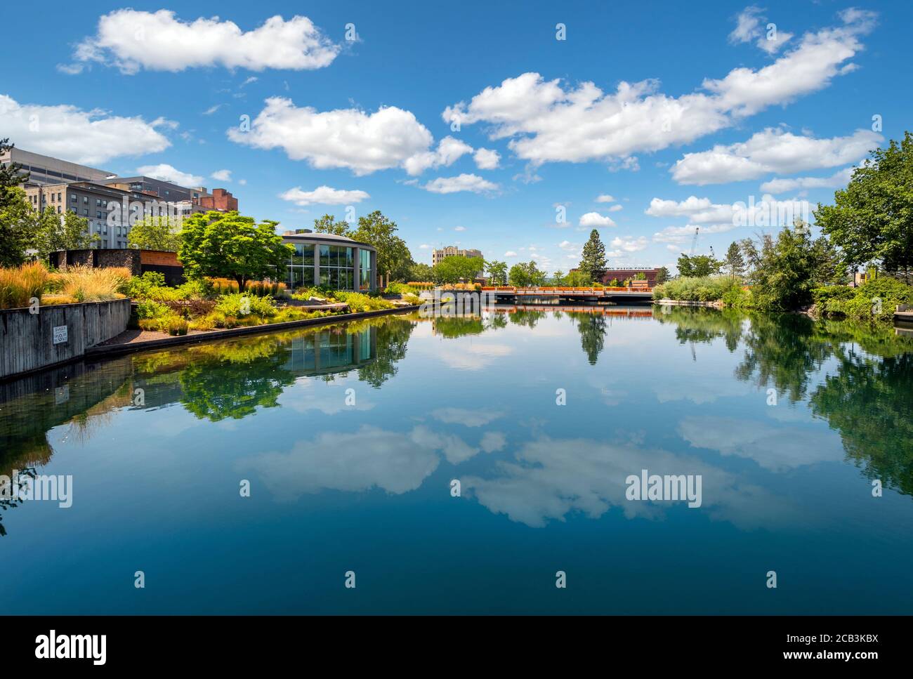 Clouds reflect off of the Spokane River with the Looff Carousel ...