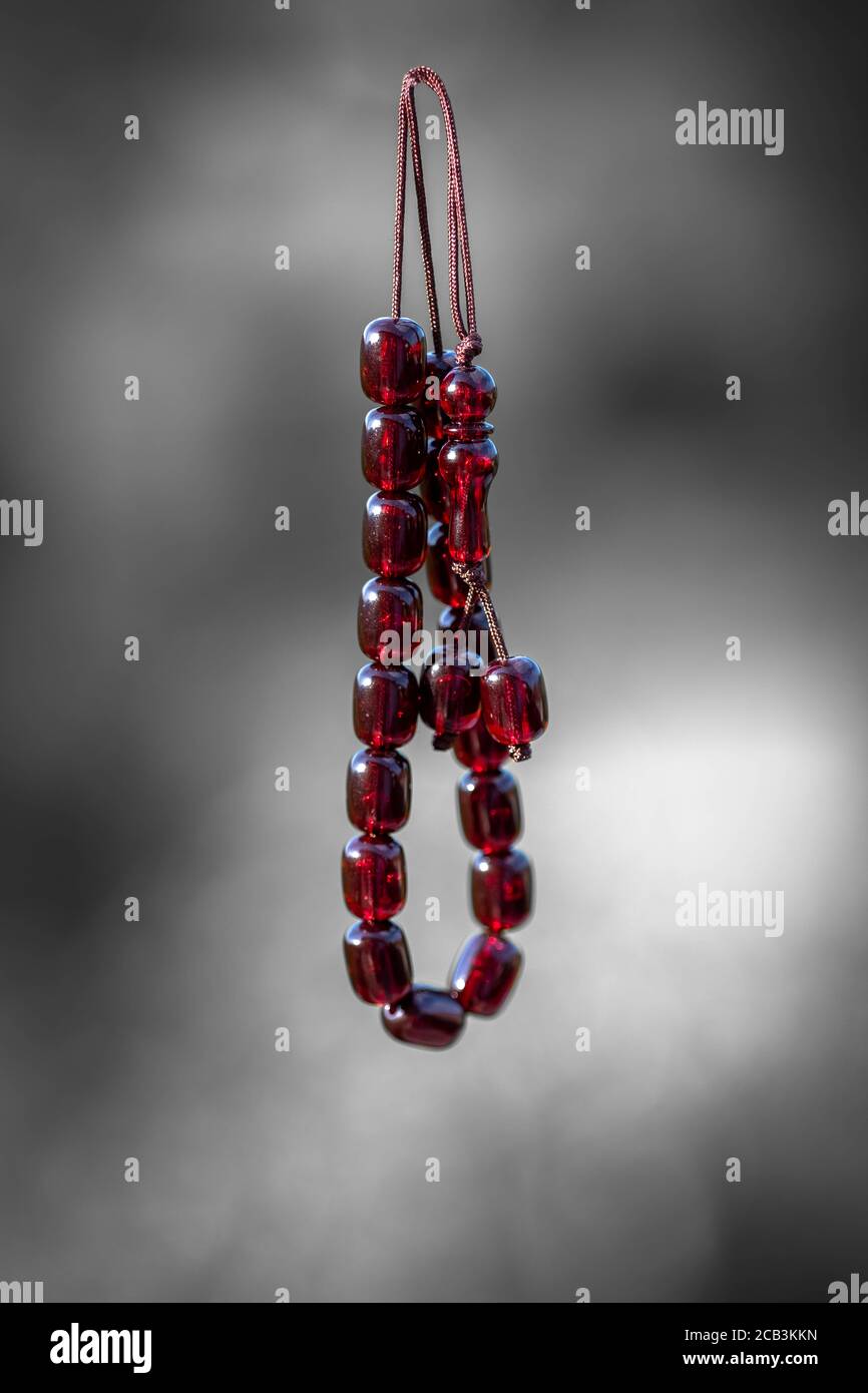 Greek worry beads. Amber greek traditional rosary on blurry background ...