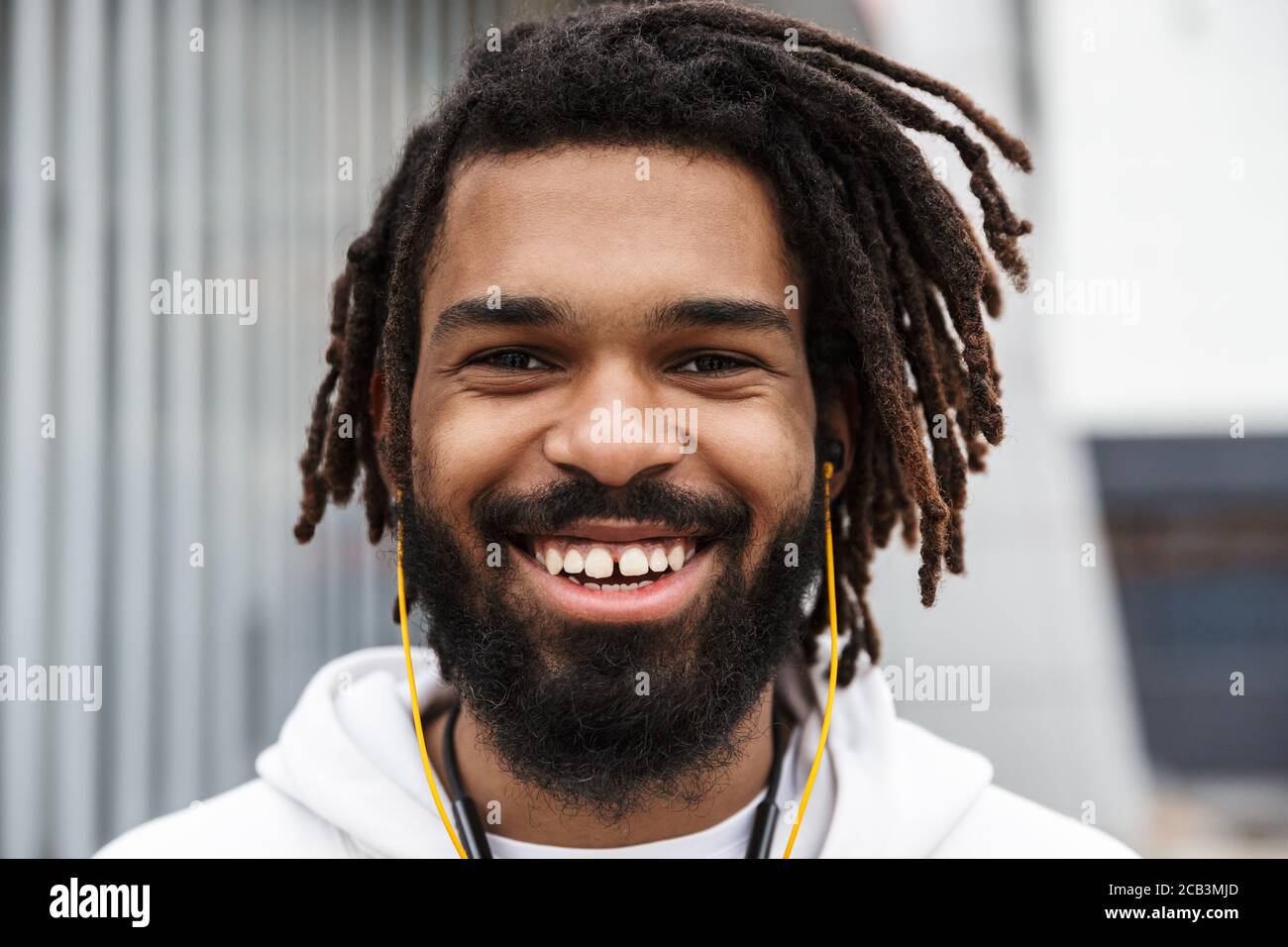 Image of a handsome positive optimistic young man walking outdoors ...