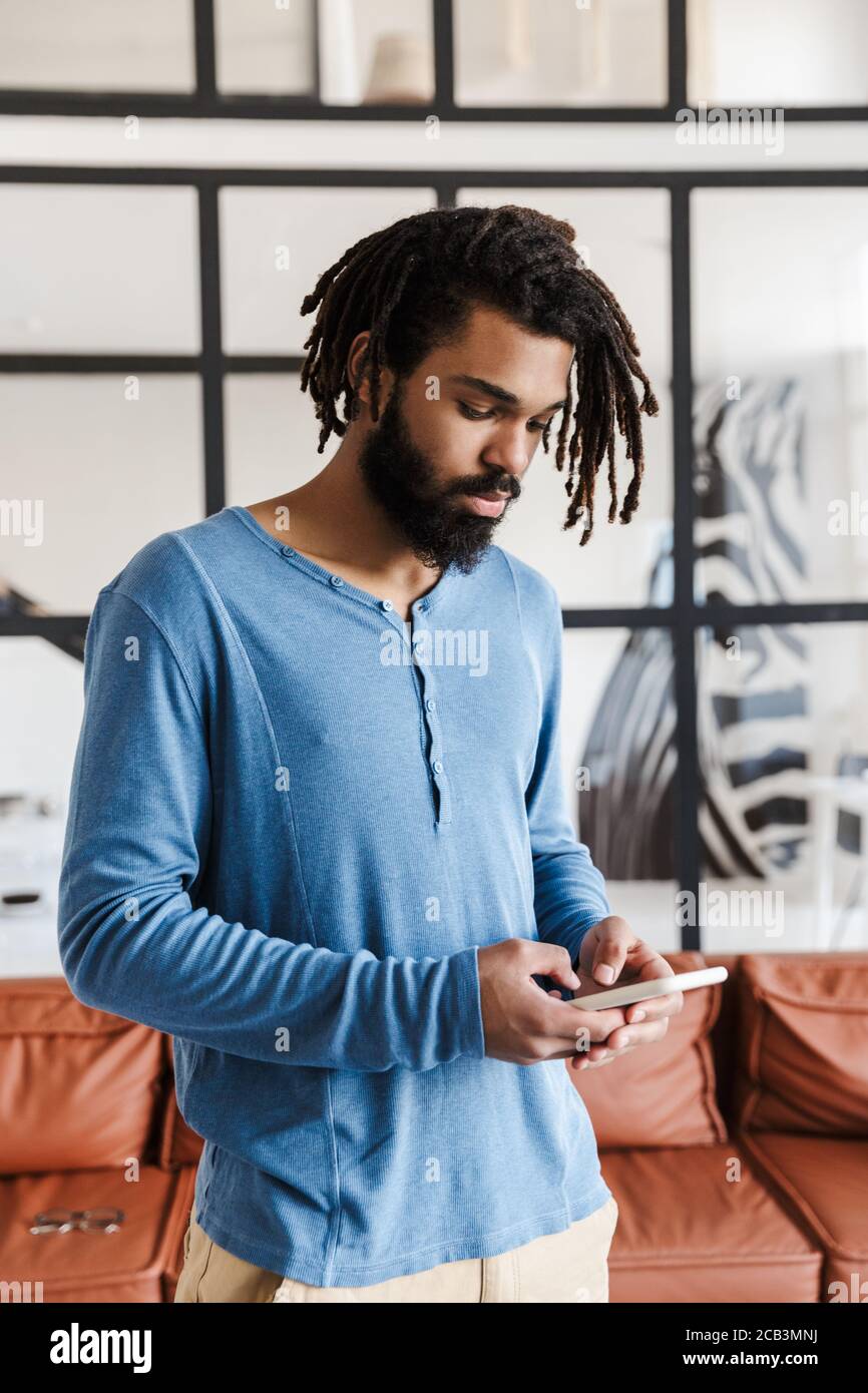 Serious young african man using hi-res stock photography and images - Alamy