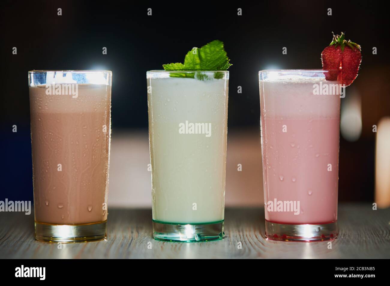 Three different colorful berry smoothies with twinkling party lights ...