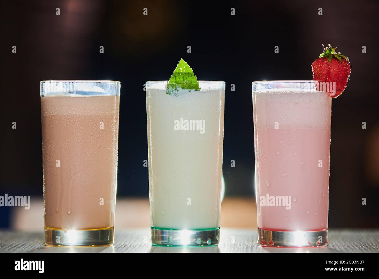 Three different colorful berry smoothies with twinkling party lights ...