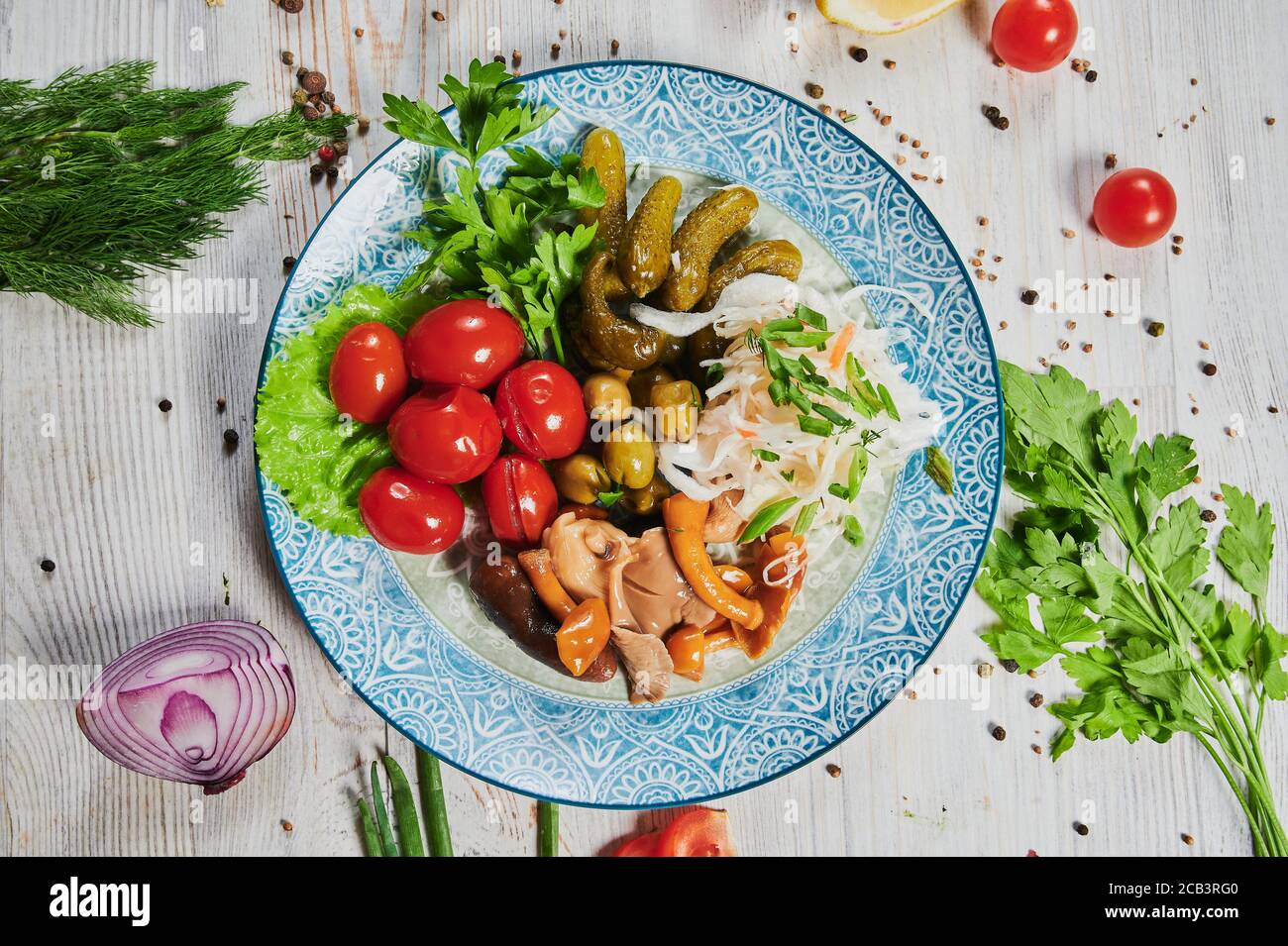 Dinner table with meat grill, roast new potatoes, vegetables, salads ...